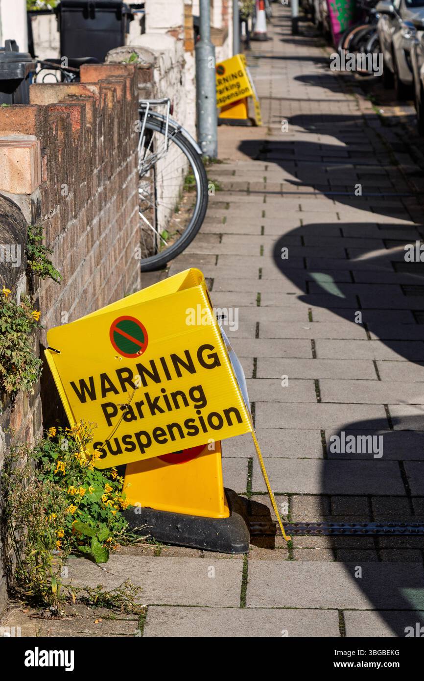 Yellow Warning Parking Suspension signs on a residential street ...