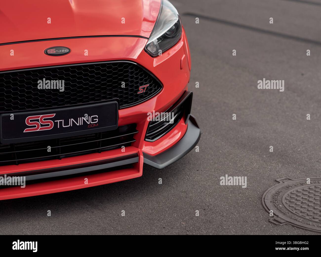 Front end of red sporty car. Close-up view of modified Ford Focus with ...