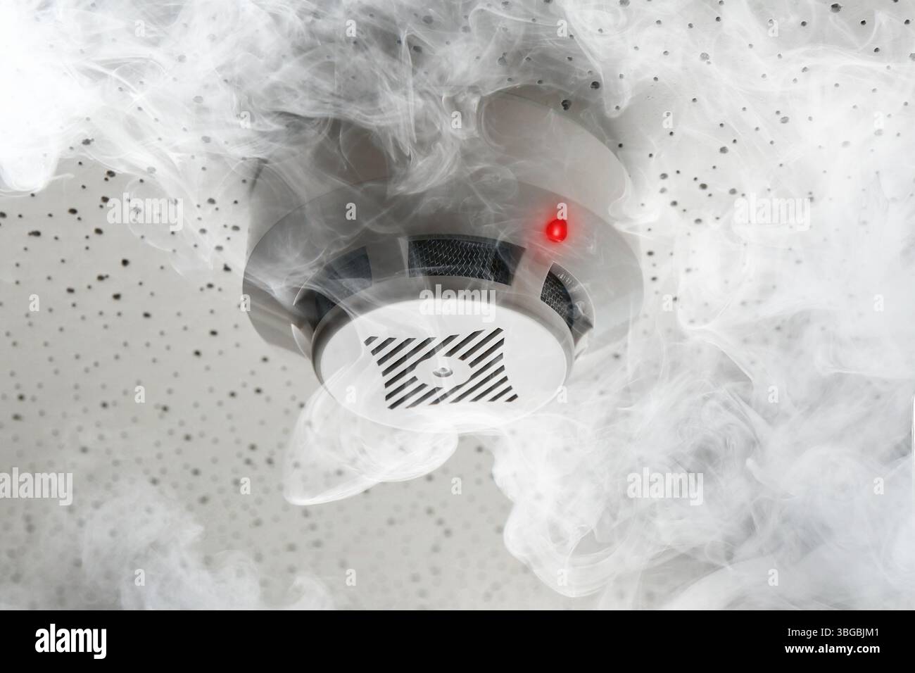 Fire alarm system. Detector on ceiling triggered by smoke Stock Photo ...
