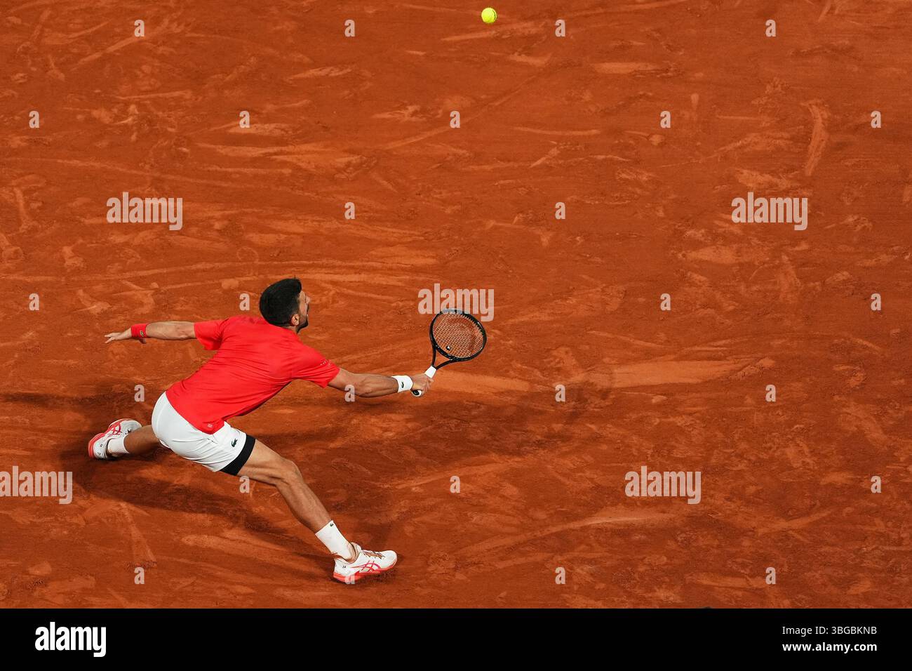 Serbia's Novak Djokovic slides for the ball against Germany's Alexander ...