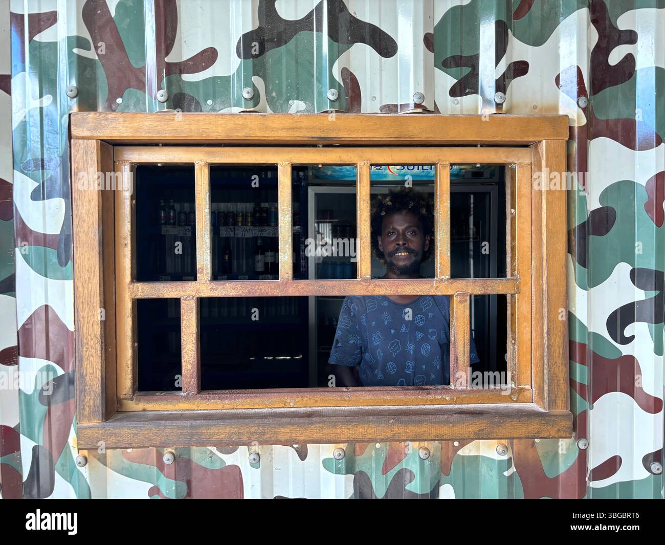 Man working in fortified alcohol shop, Munda, Western Province, Solomon ...