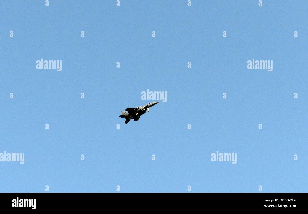 An American F-15 Eagle fighter Jet flying over Chatan, Okinawa, Japan ...