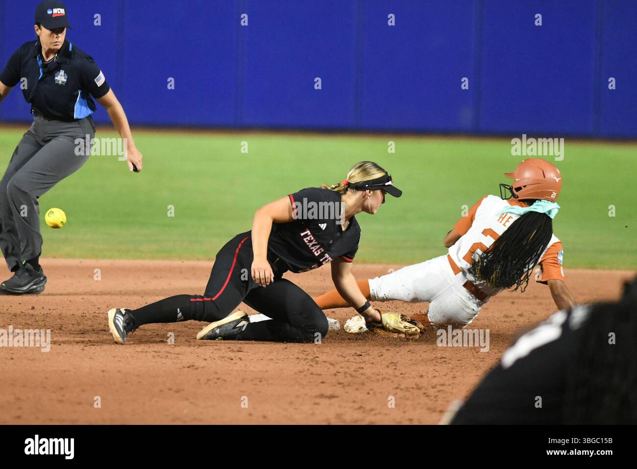 Texas Tech infielder Alexa Langeliers loses the ball as she tries to ...
