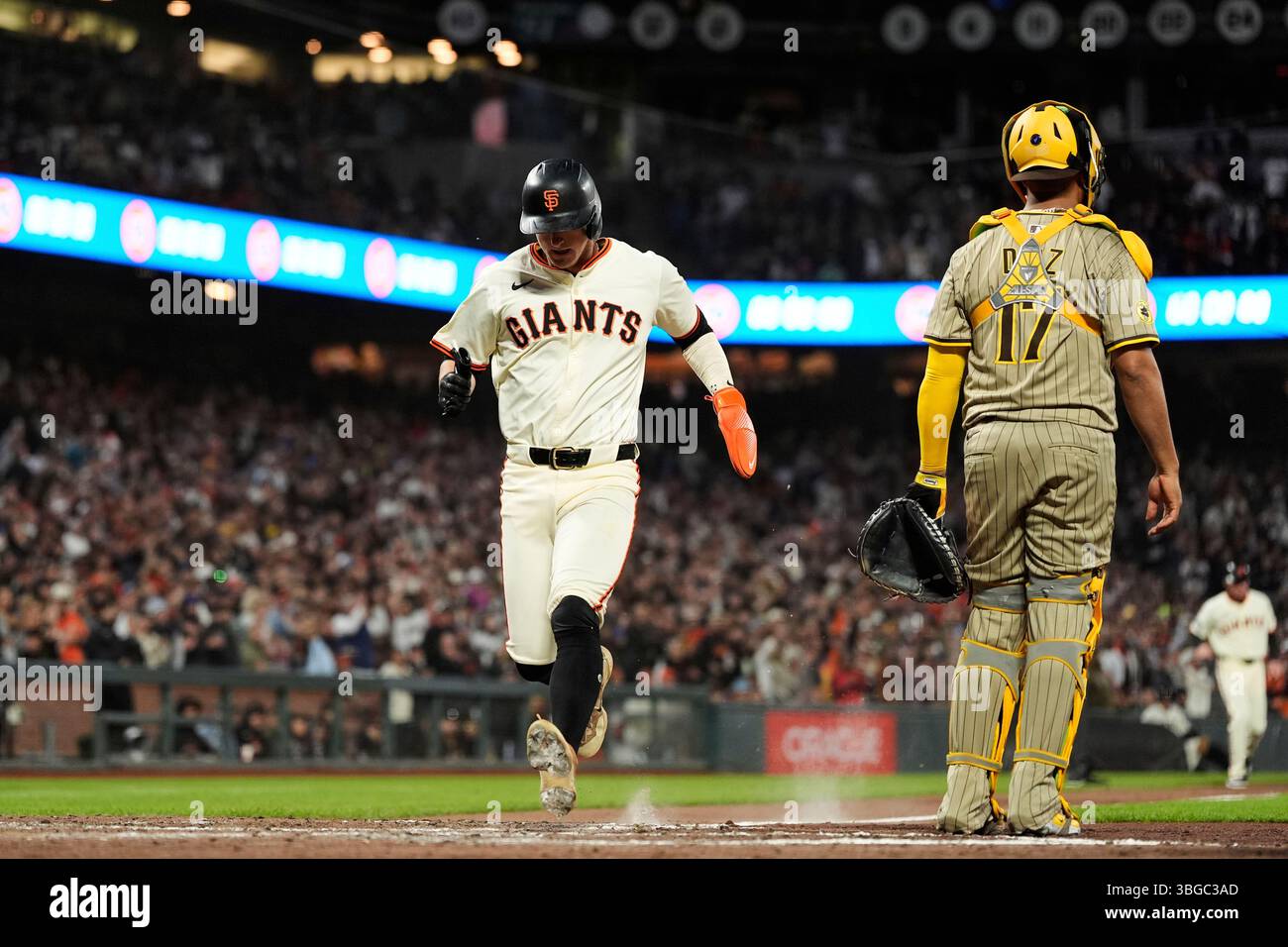 San Francisco Giants' Tyler Fitzgerald, left, scores against the San ...