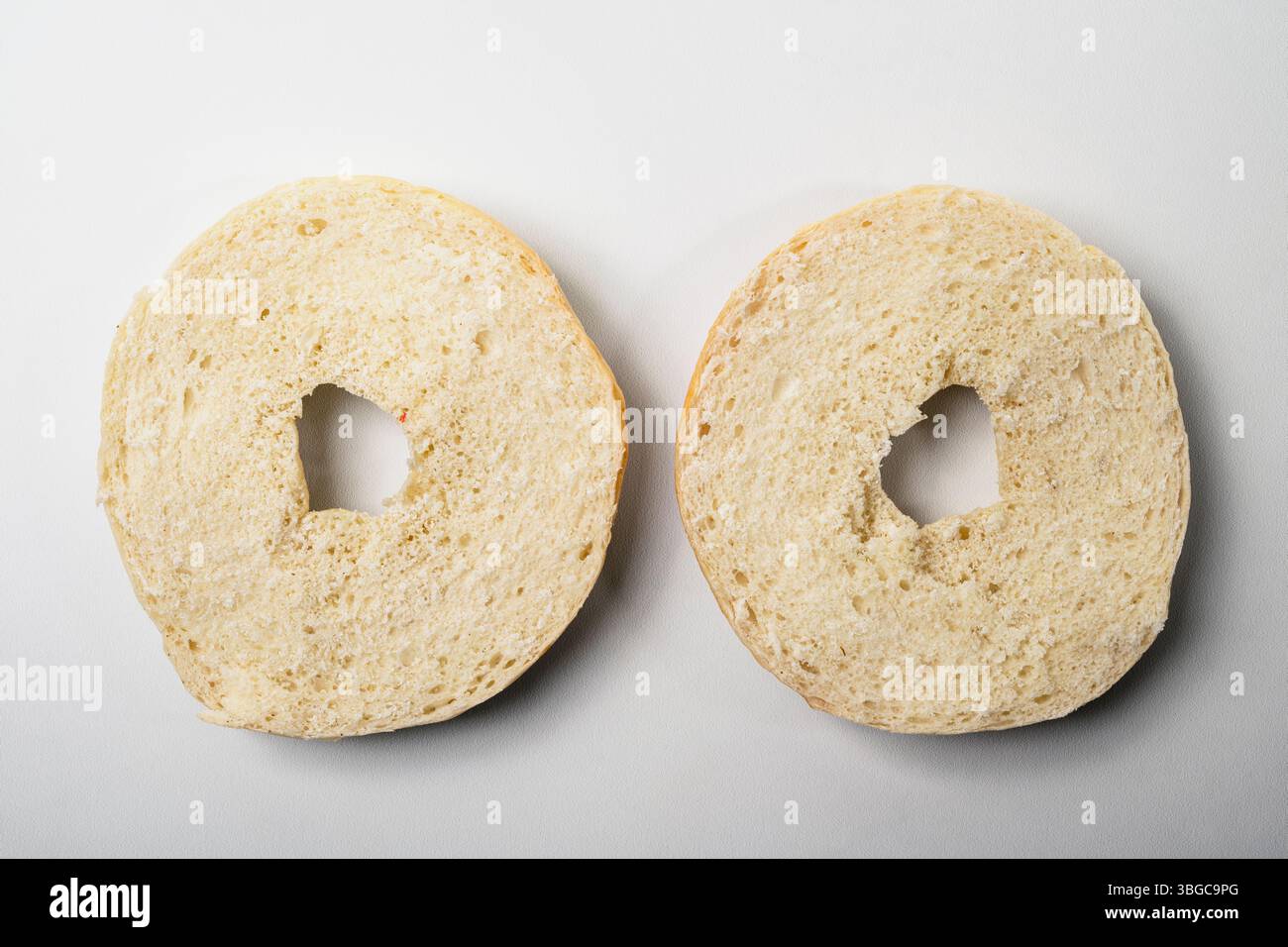 Closeup view of slice of bagel breads isolated over white background ...