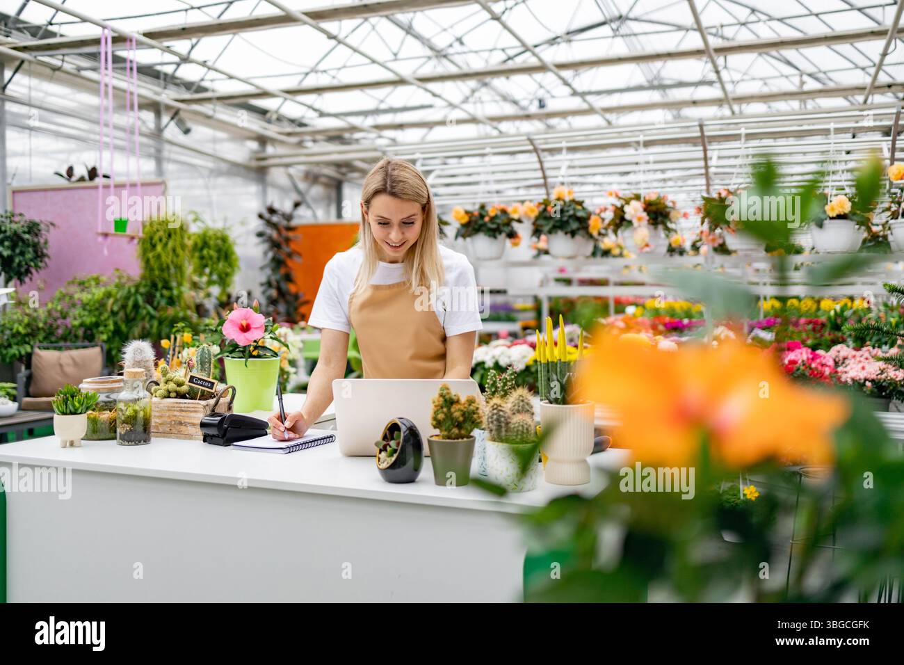Woman in apron writing notebook hi-res stock photography and images - Alamy