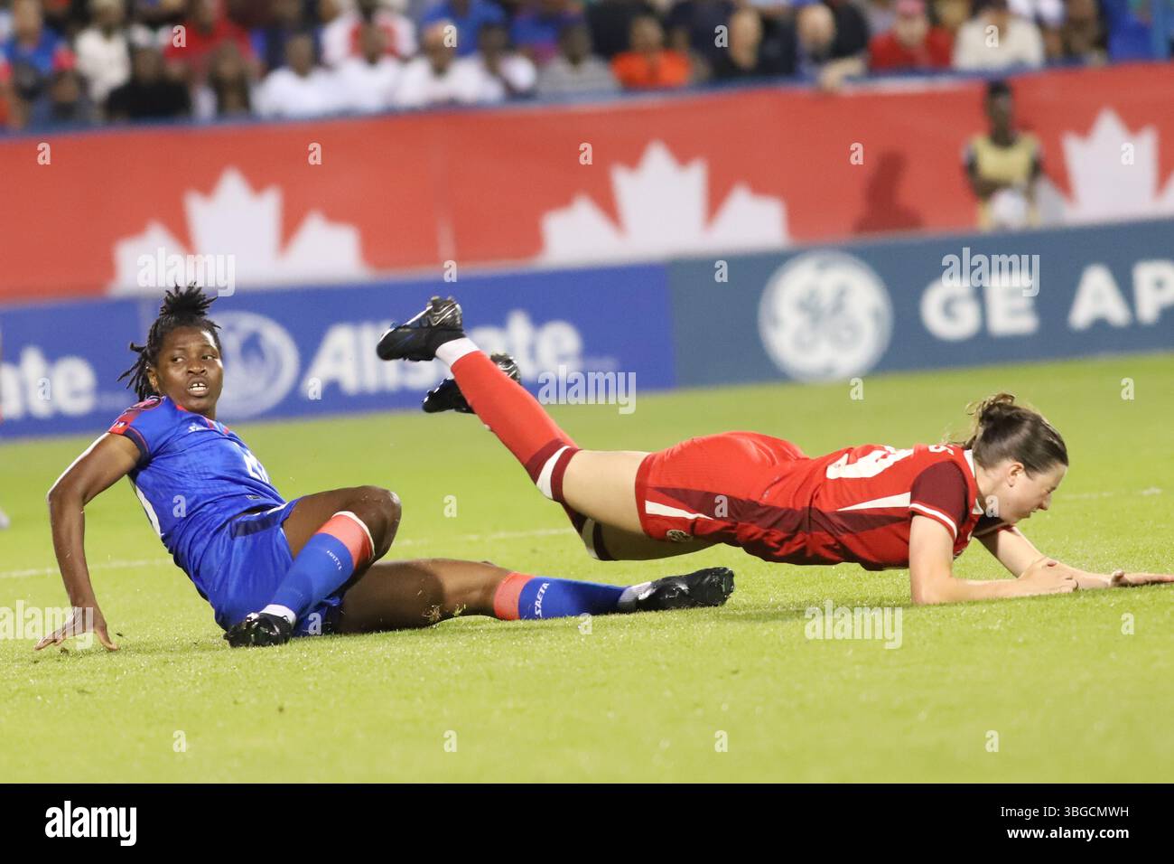 Kethna Louis #20 of Haiti and Kayla Briggs #29 of Canada battle for the ...