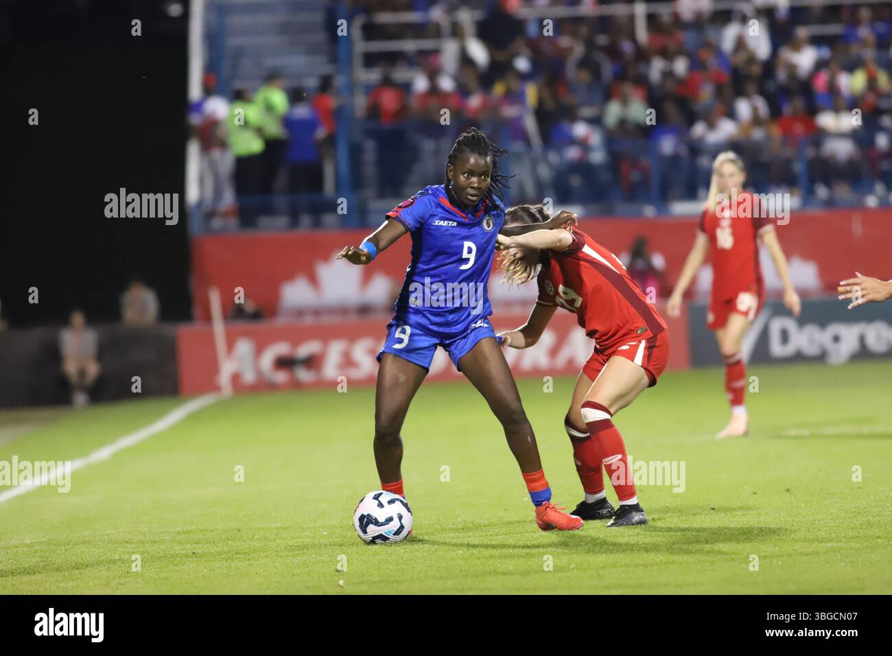 Sherly Jeudy #9 of Haiti and Kayla Briggs #29 of Canada battle for the ...