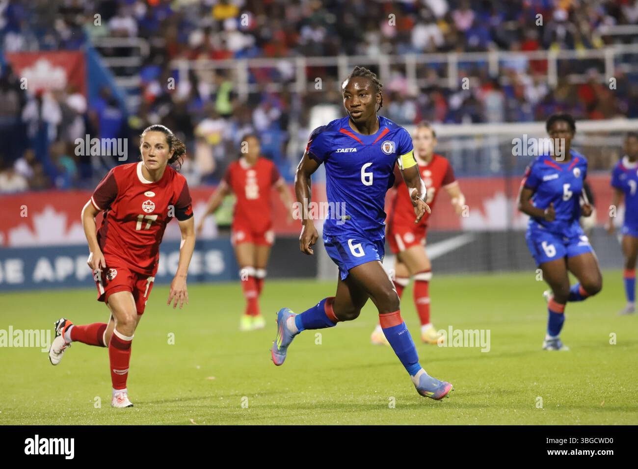 Melchie Dumornay #6 of Haiti and battle for the possesion Jessie Fleming #17 of Canada during ...
