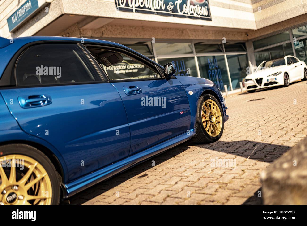 Milan, italy 4 june 2025, a blue subaru impreza wrx sti with gold rims ...