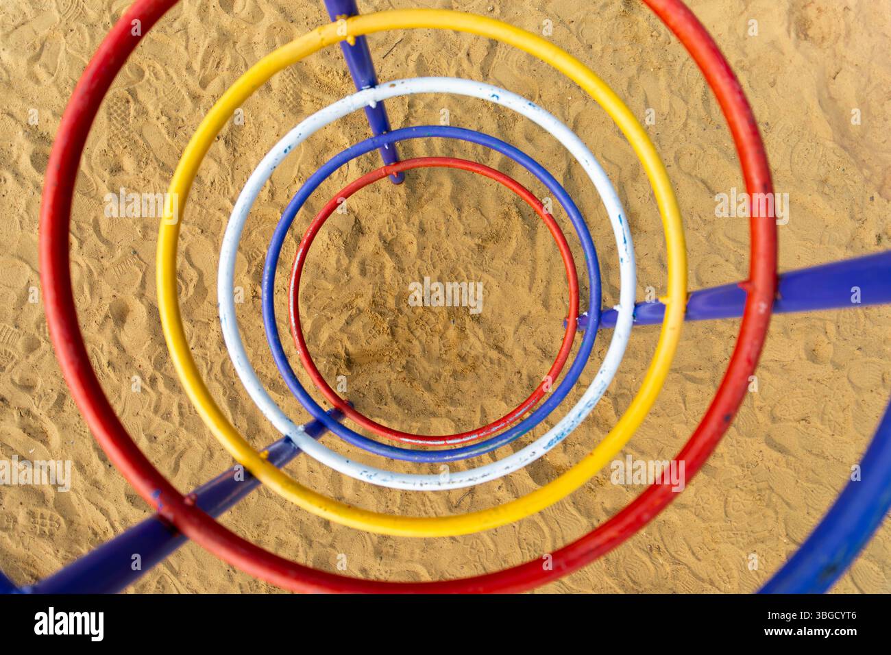 Overhead view of multicolored metal climbing rings forming a spiral ...