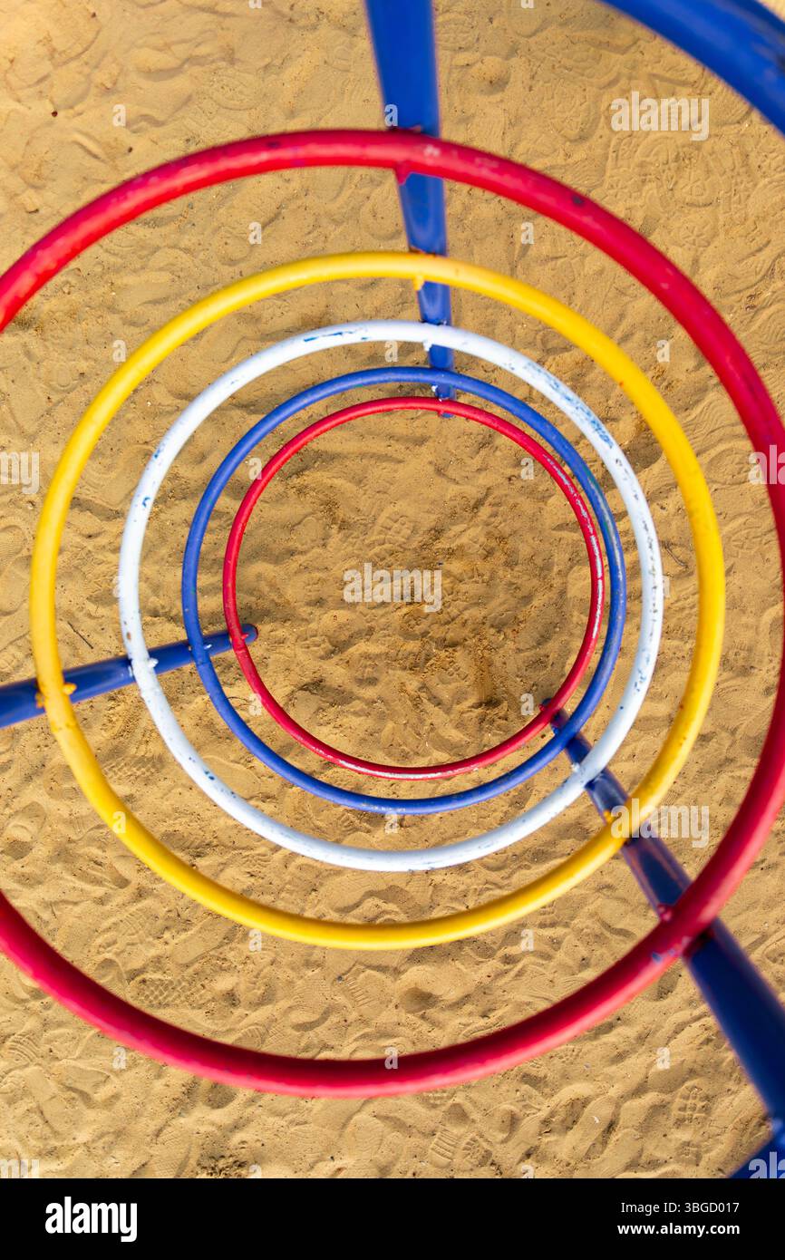 Vertical view of colorful metal climbing rings in a spiral pattern over ...