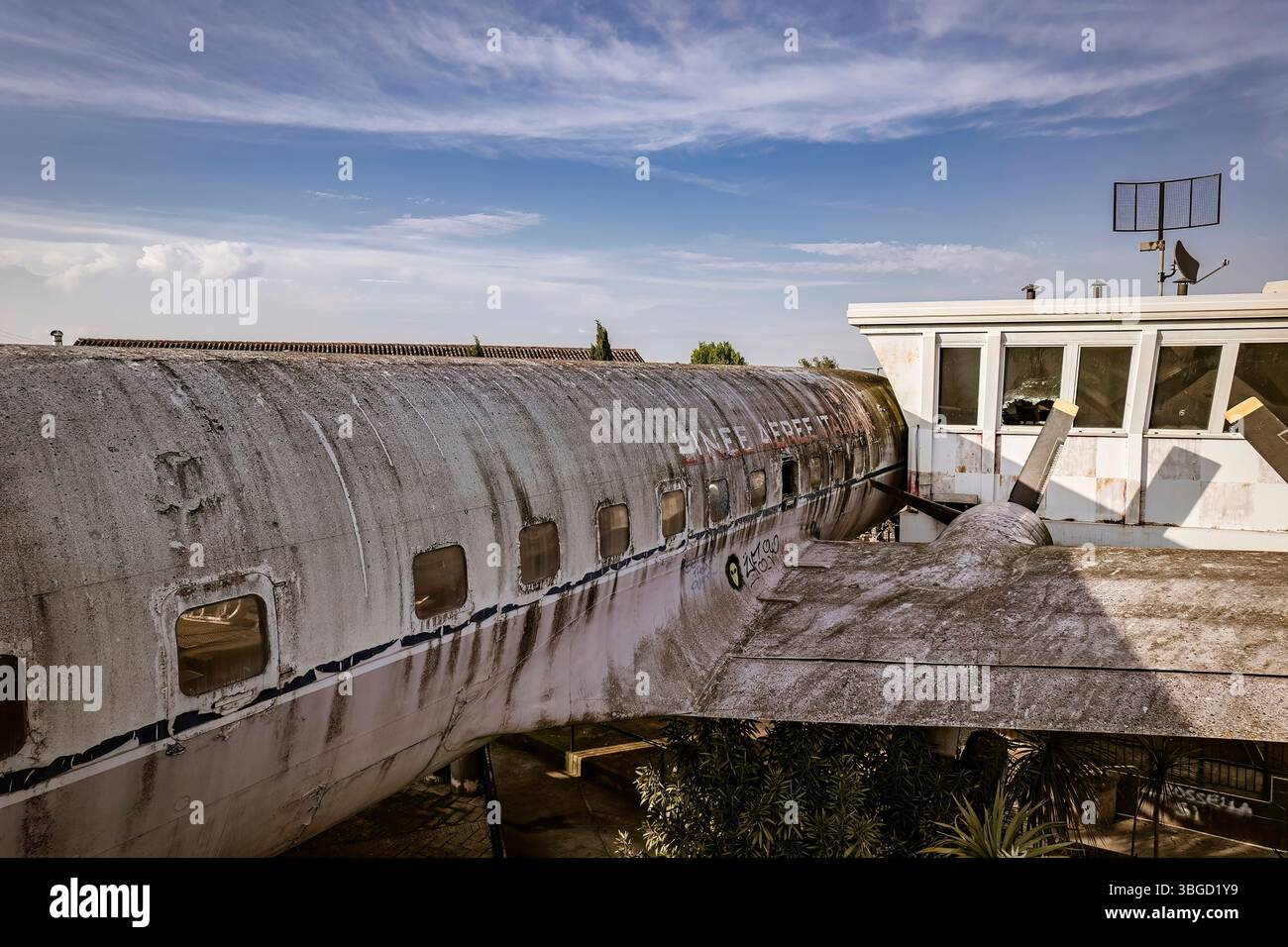 Decaying airplane fuselage with peeling paint, showing signs of age and ...