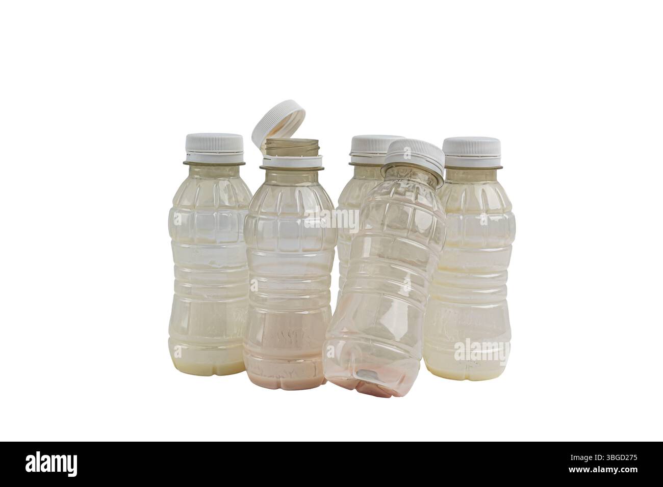 dirty empty plastic bottles from under yogurt on a white background ...