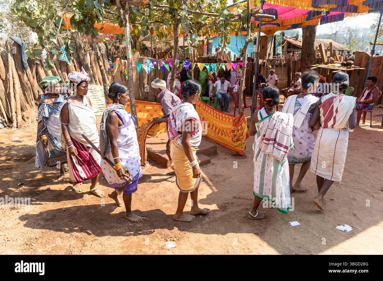 Guests in traditional clothes performing religious ritual around the ...
