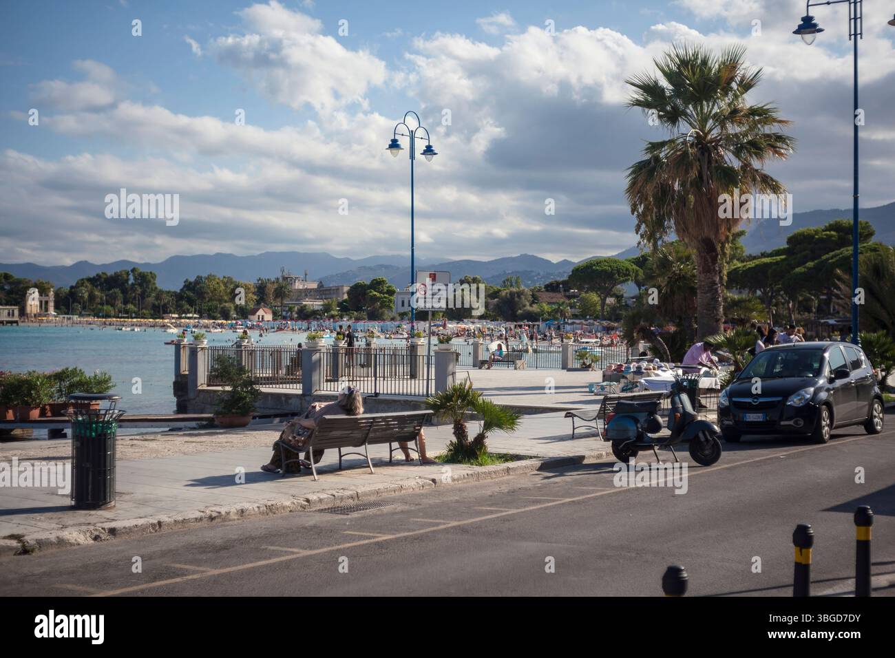 Mondello, Italy 1 January 2025: Elderly woman resting on a bench ...