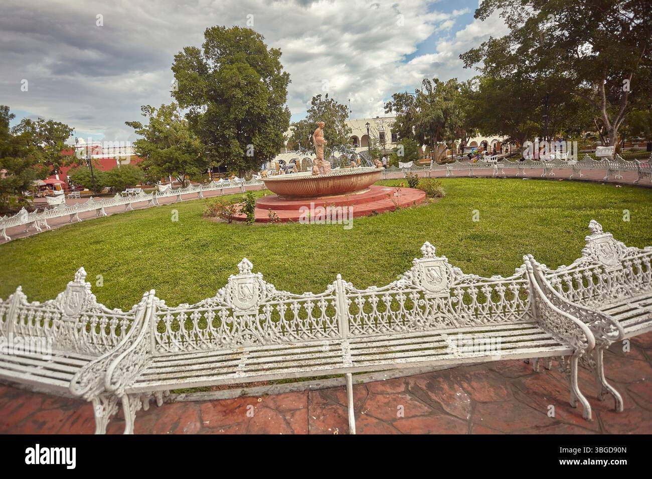 Valladolid, Mexico 1 January 2025: White benches surrounding a fountain ...