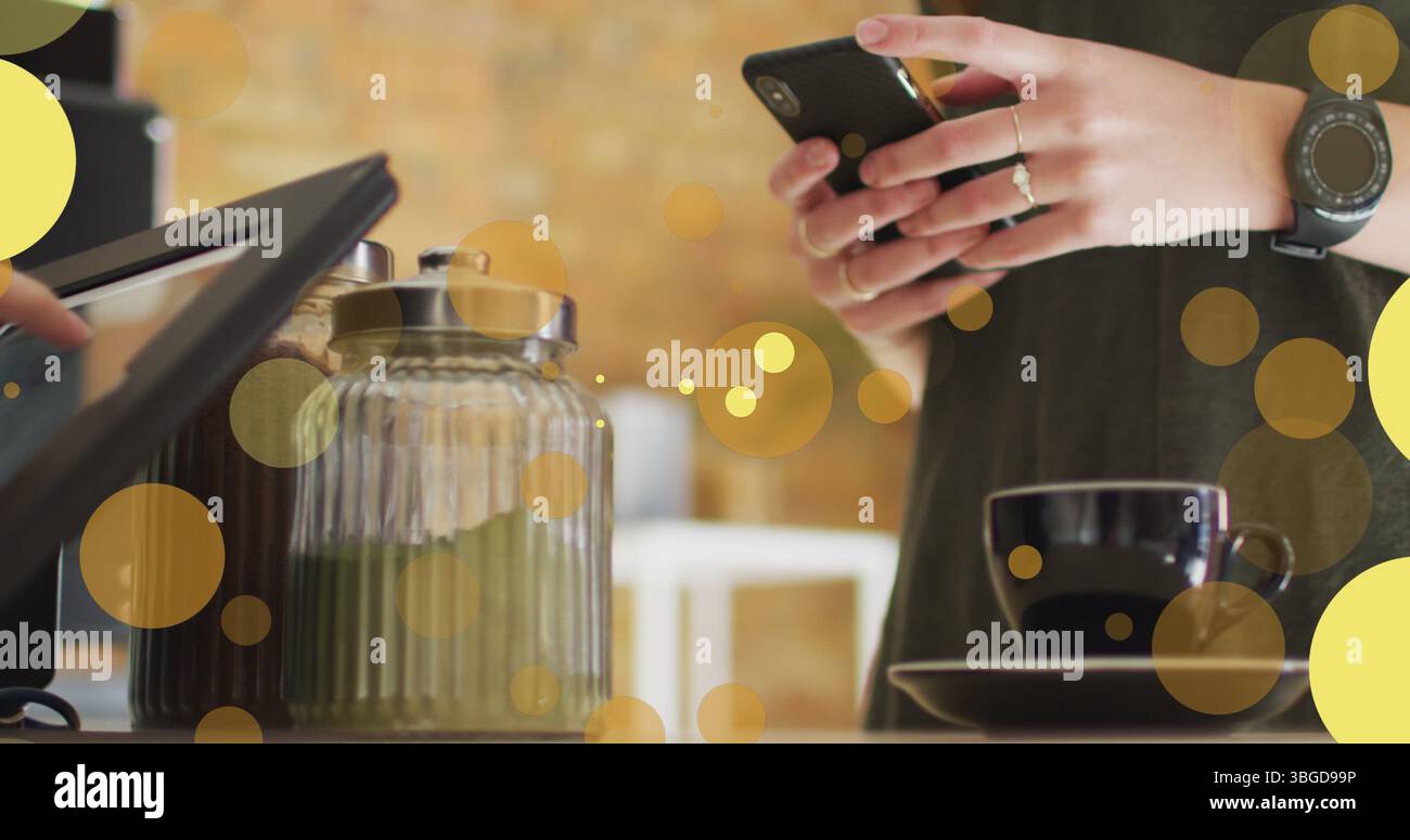 Image of falling yellow dots over people using payment terminal Stock ...