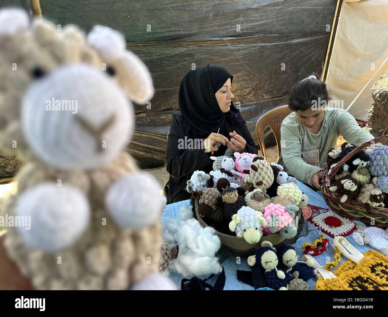 The Palestinian displaced woman, Reham Sharab, 30, uses her crochet ...