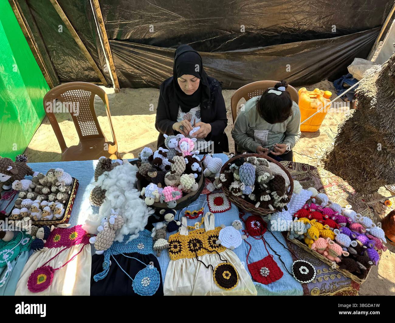 The Palestinian displaced woman, Reham Sharab, 30, uses her crochet ...