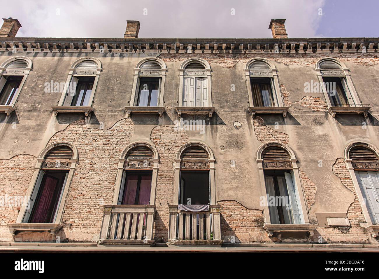 Venice, Italy 1 January 2025: Crumbling facade of an old residential ...