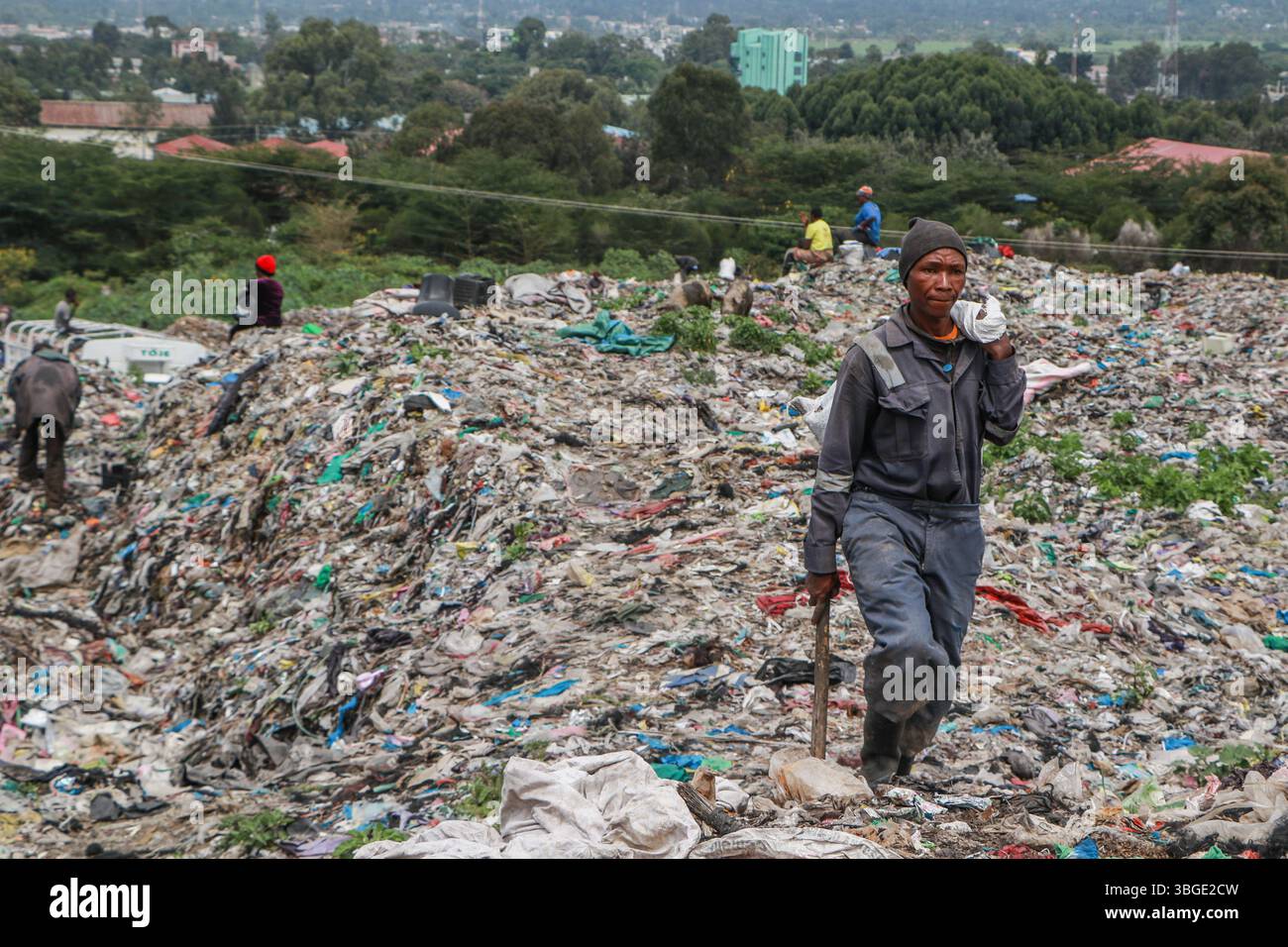 Informal waste workers collect materials to recycler at Gioto dumpsite ...