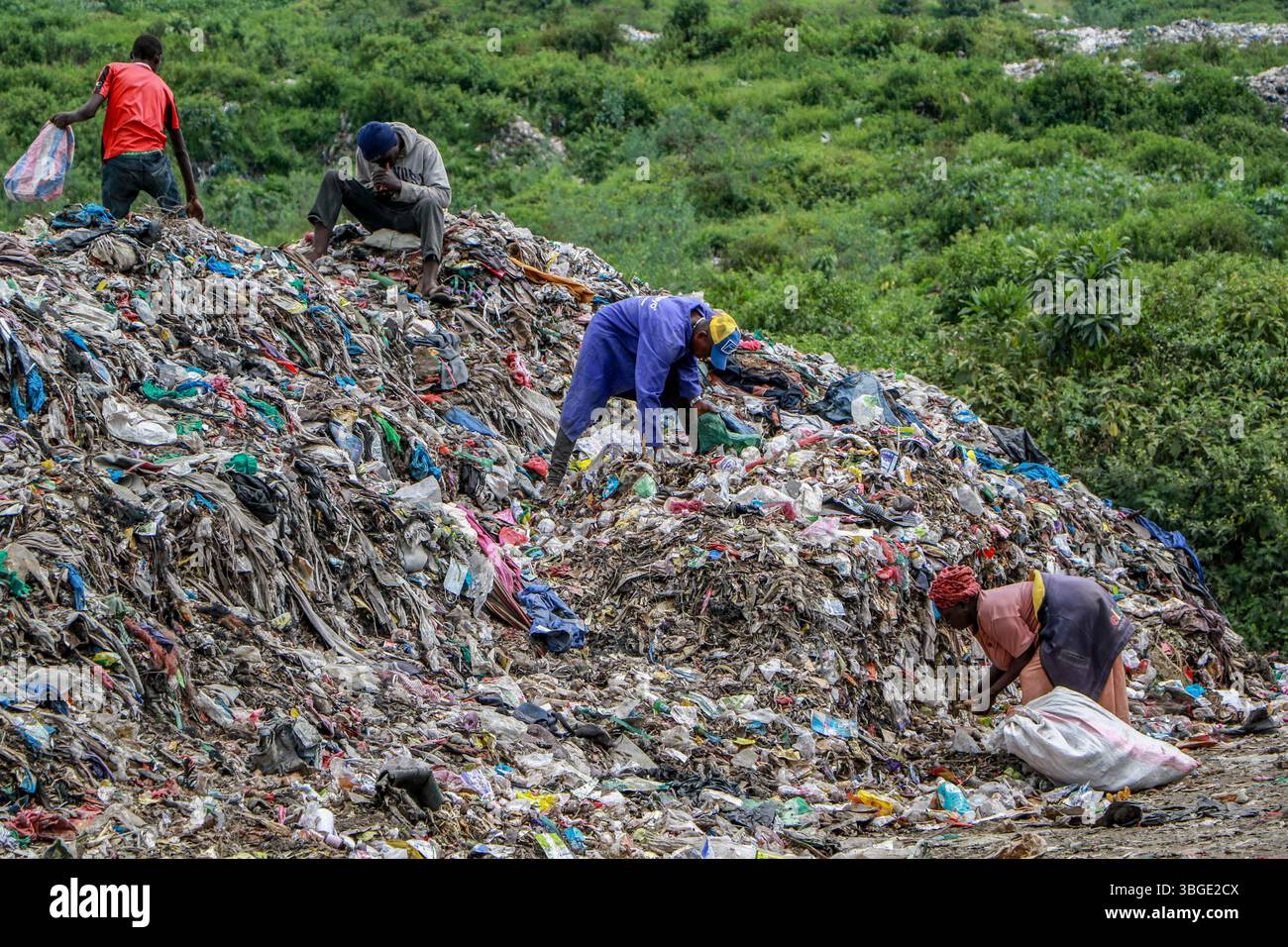 Informal waste workers collect materials to recycle at Gioto dumpsite ...