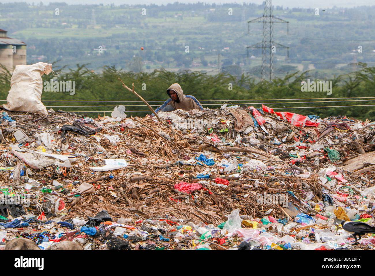 Nakuru, Kenya. 04th June, 2025. An informal waste worker collects ...
