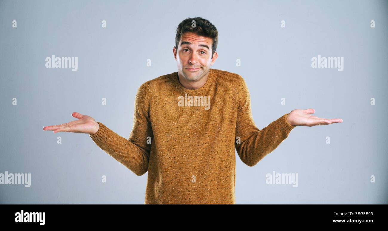 Confused, portrait and shrugging shoulders with man in studio for doubt ...