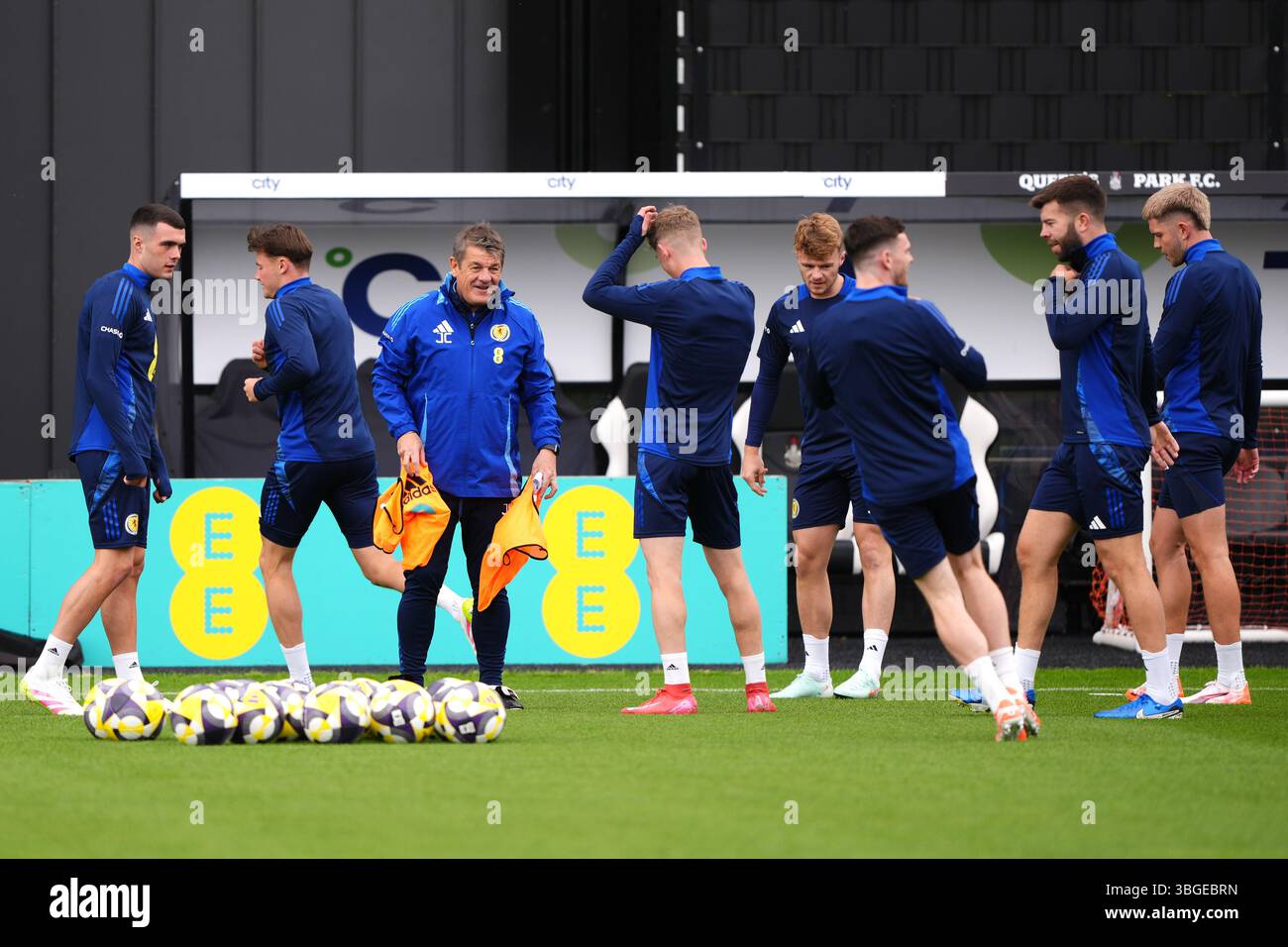 Scotland assistant coach John Carver (third left, facing) with players ...