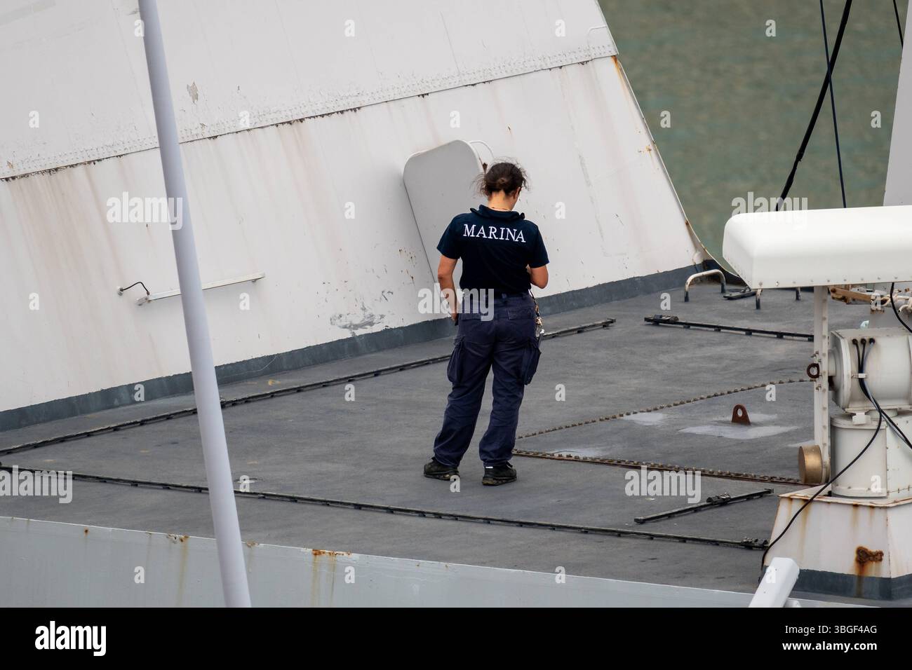 Genoa, Italy - June 5, 2025: A member of the Italian Navy stands on the ...