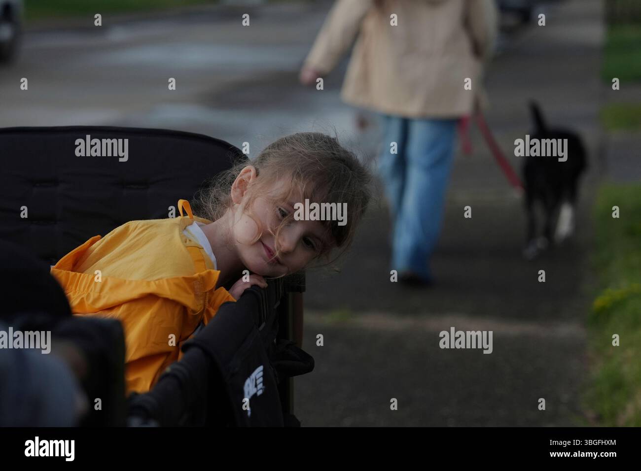 Eliza Ethridge, 5, rides in a wagon during a walk with her family ...