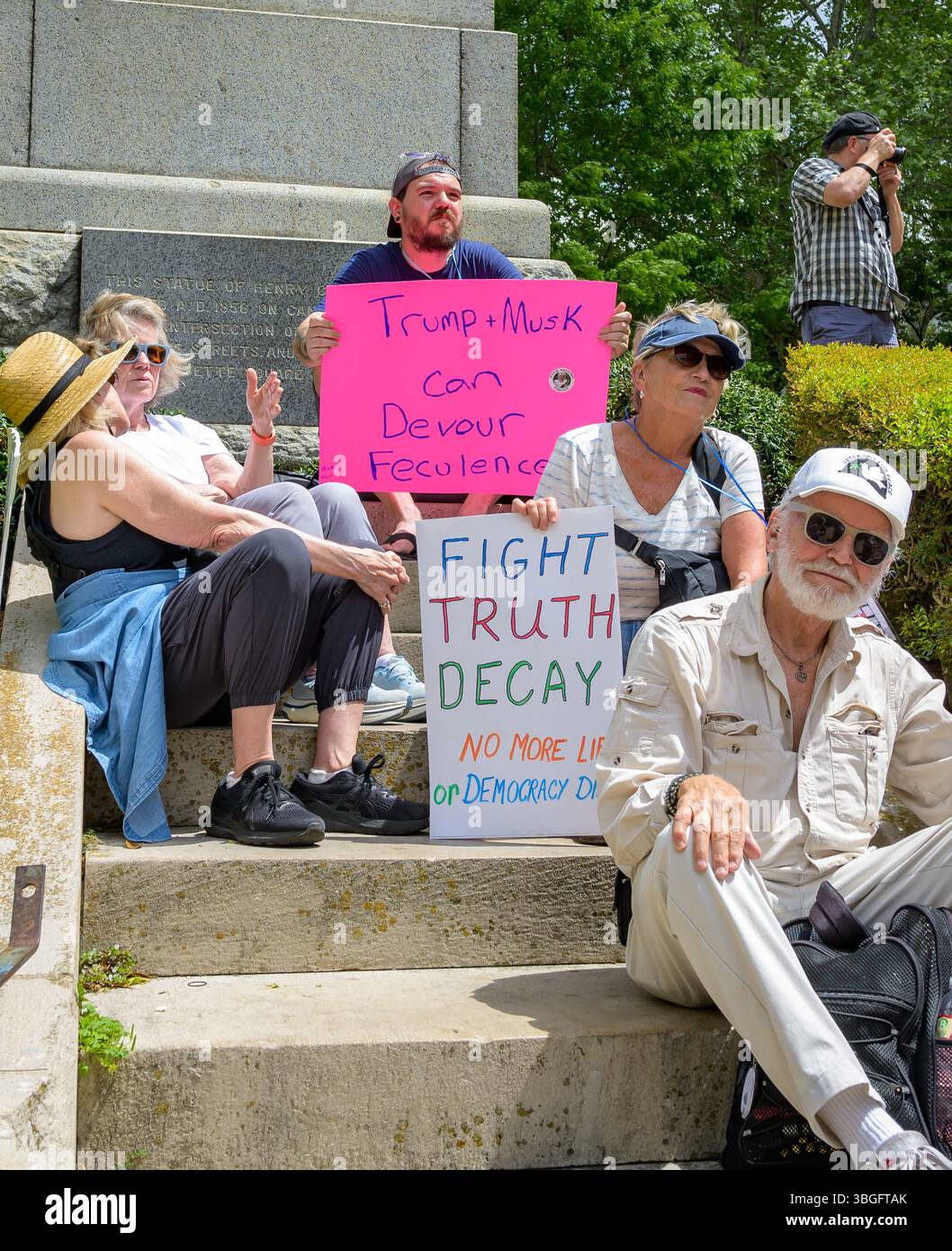 New Orleans, LA, USA - April 5, 2025: Protesters with signs on monument ...