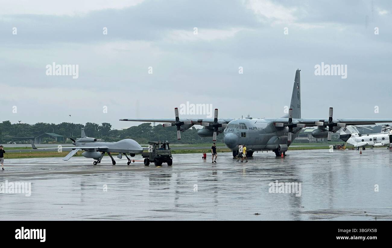 A U.S. Navy drone, left, is seen beside a Philippine C130 plane at the ...