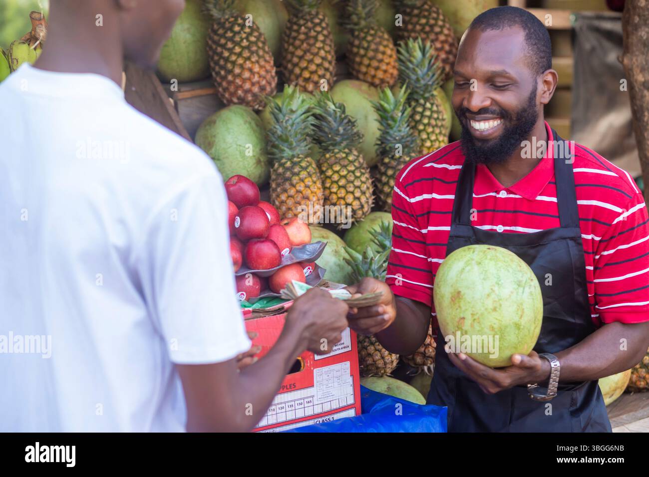 african man selling in a market counting money Stock Photo - Alamy
