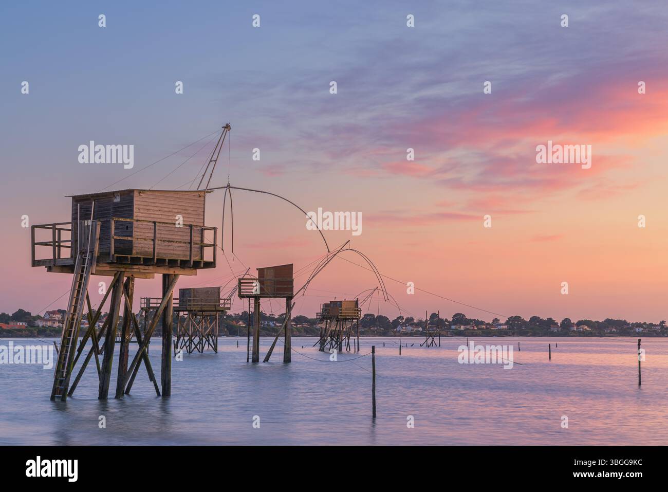Traditional fishing huts at sunset on Tharon beach at high tide in ...