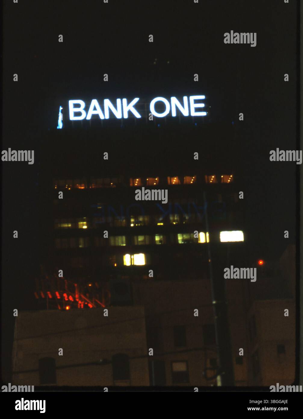 A color photograph of the Bank One sign illuminated at night in 1980 ...