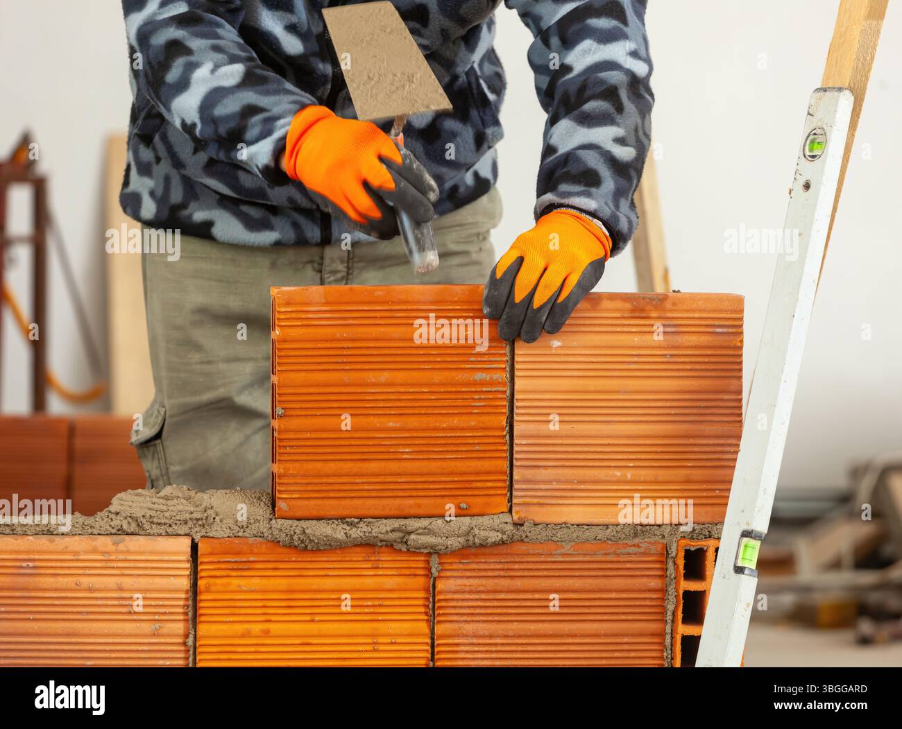 Bricklayer placing hollow brick mortar hi-res stock photography and ...
