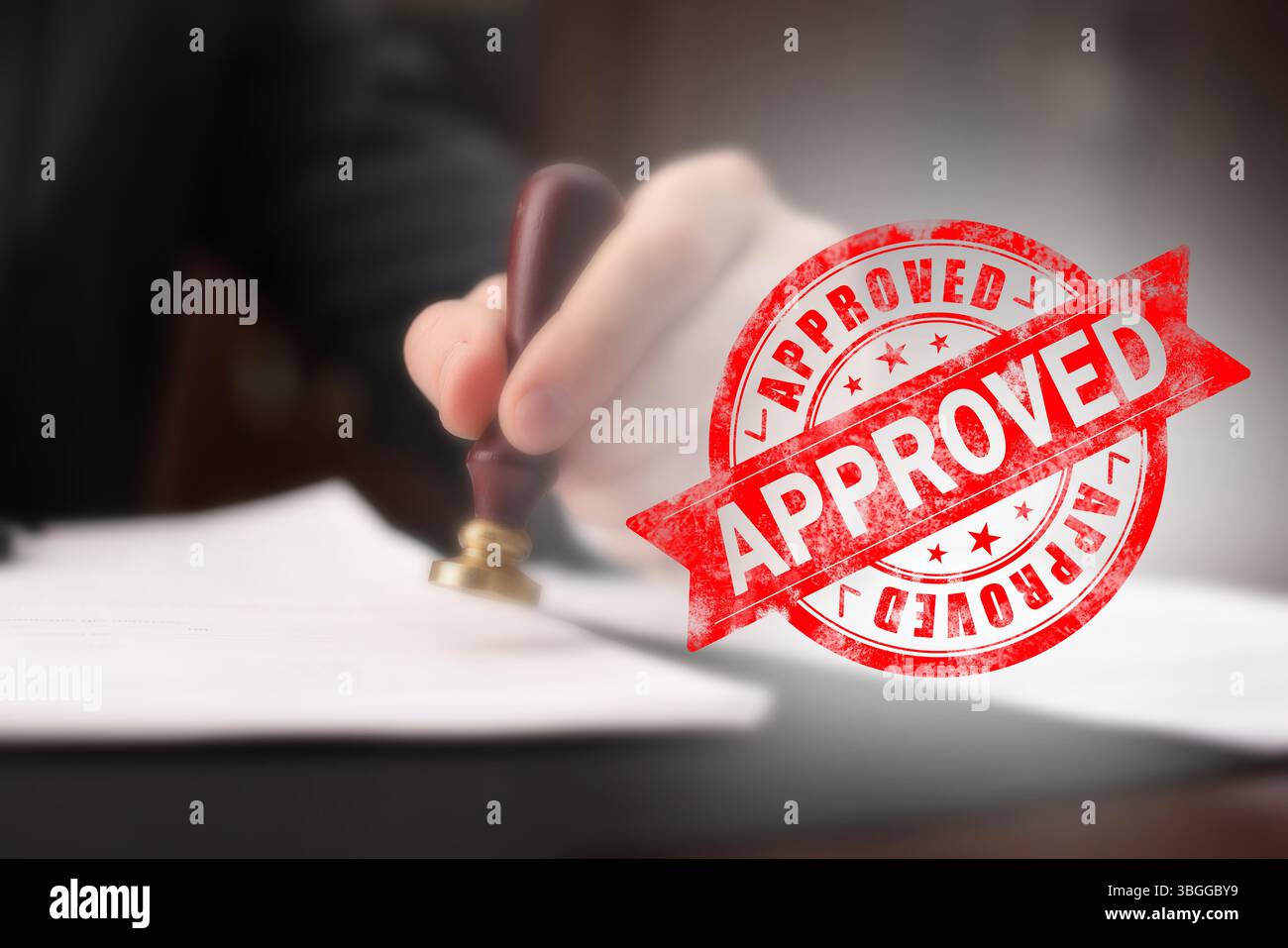 Man stamping document at table and red stamp Approved Stock Photo - Alamy