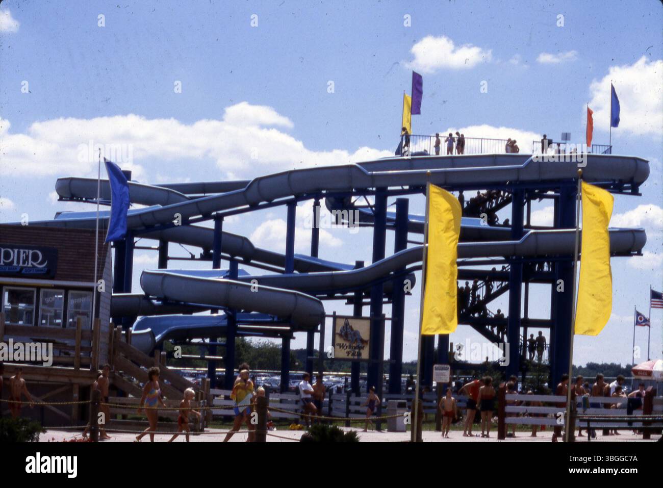 Circa August 1985, yellow, orange, blue, and purple flags welcome ...