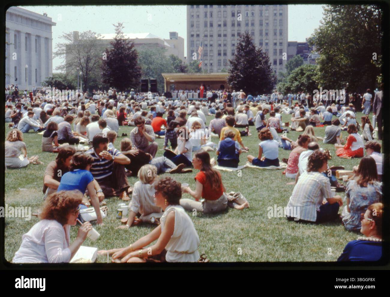 In 1980, people sit on the Ohio Statehouse lawn attending an outdoor ...