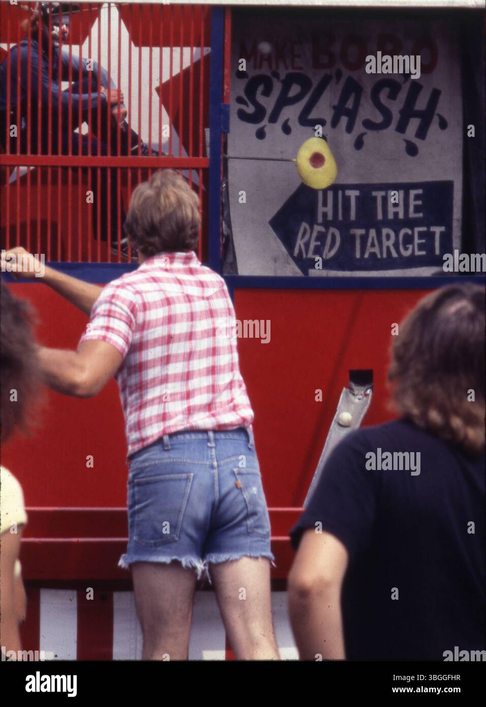 At the Ohio State Fair, a man throws a ball attempting to hit the ...