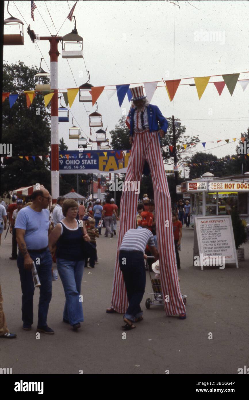 At the Ohio State Fair, Geze Geier, dressed as Uncle Sam, towers over ...