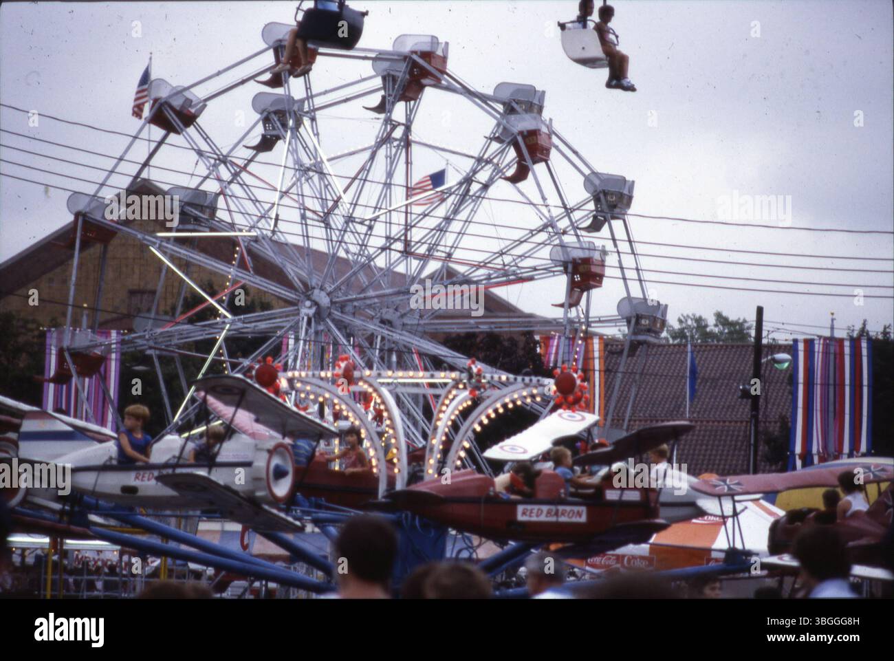 A wide view shows several amusement rides at the Ohio State Fair ...
