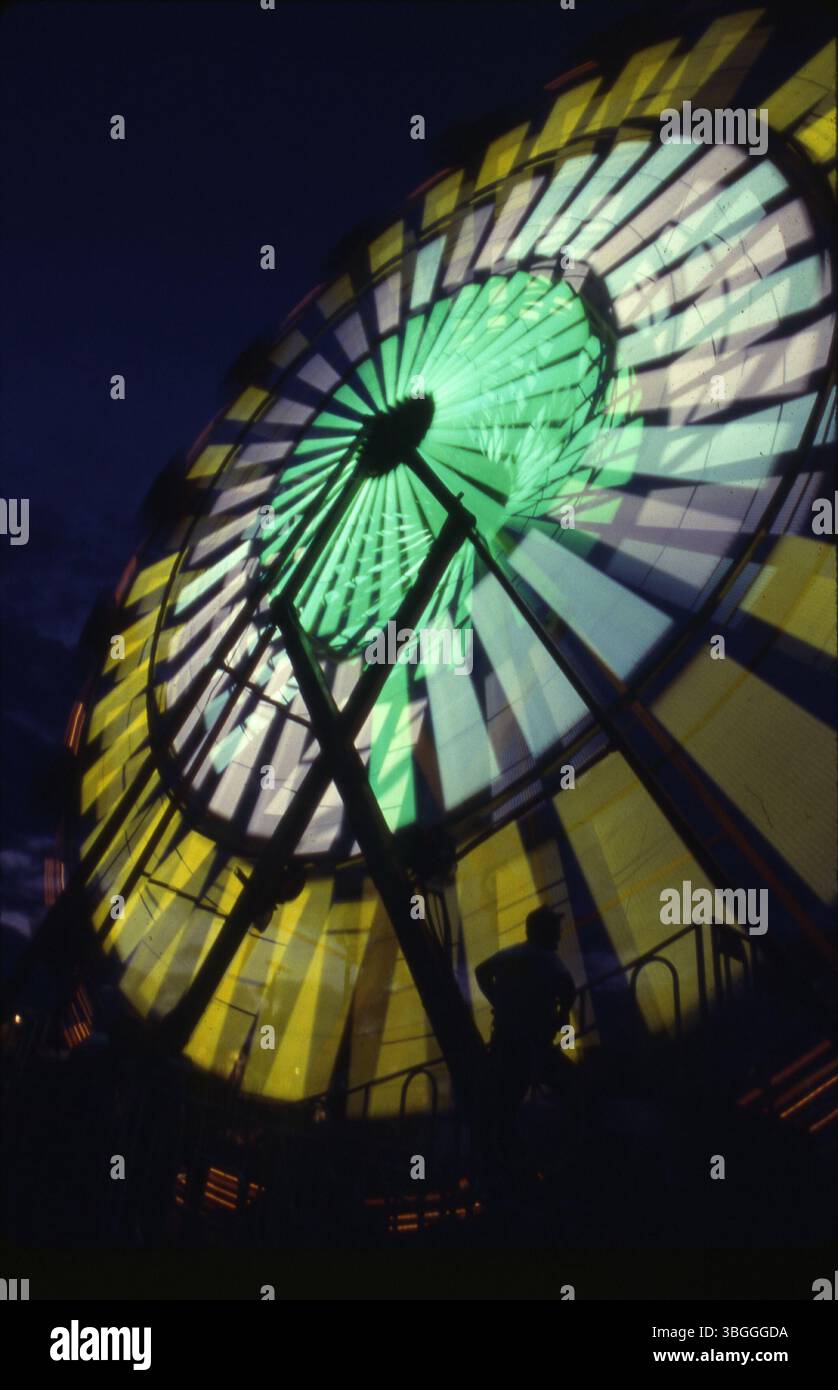 The Ferris wheel at the Ohio State Fair is lit up in yellow, white, and ...