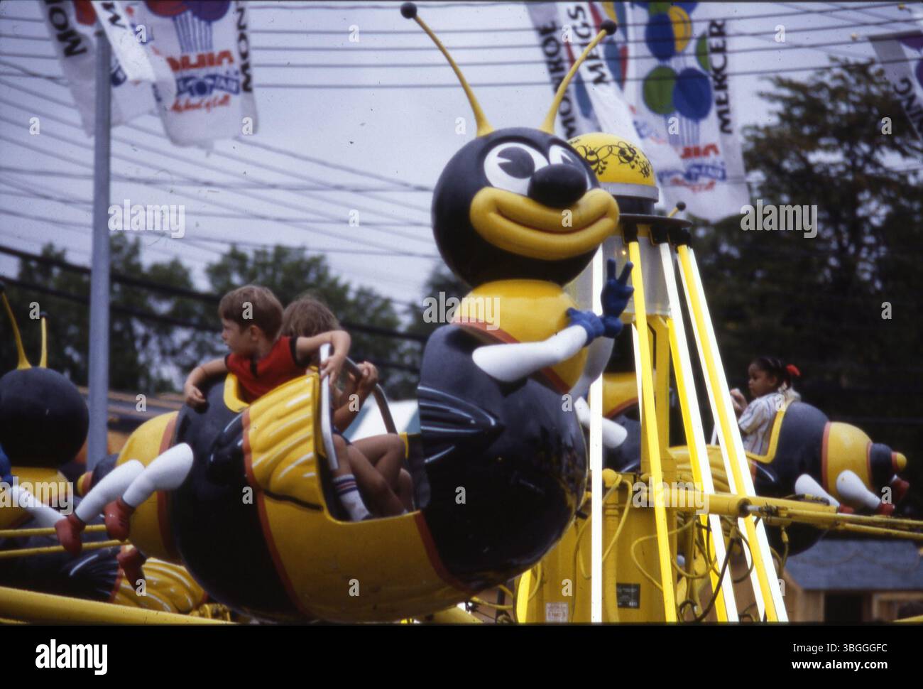 Children enjoy the Bumble Bee ride at the Ohio State Fair, where a bee ...