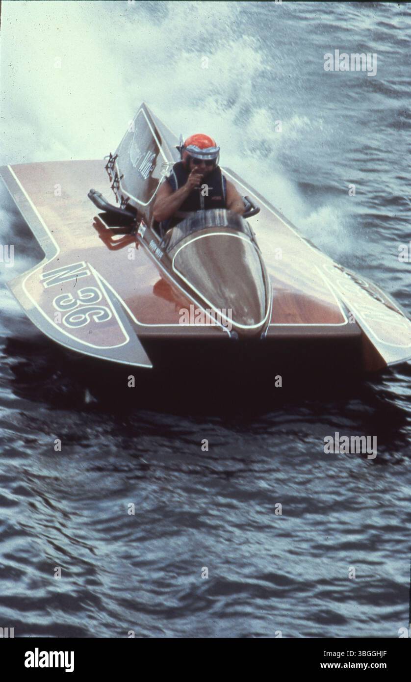 A 1977 image of Randy Wolfe pointing at the camera while driving the ...