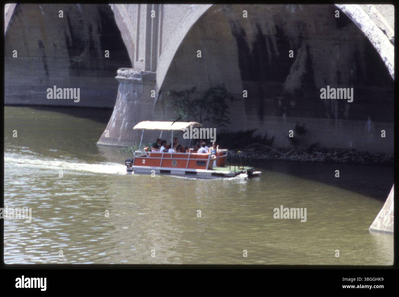 A pontoon boat with a canopy top cruises along the Scioto River in ...