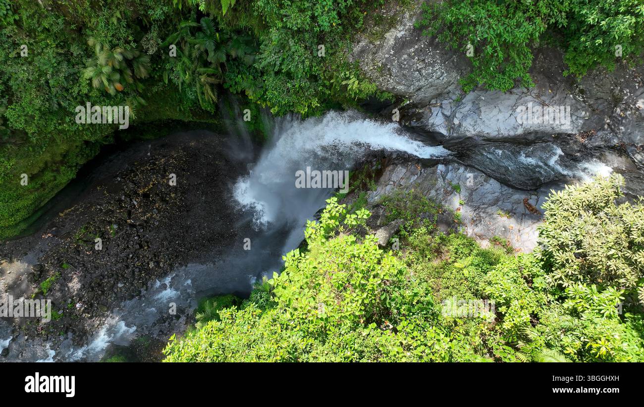 Aerial perspective of Tiu Kelep waterfall shows the river carving its way through the rocks ...
