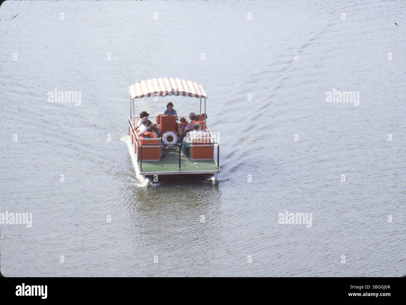 A pontoon boat with a canopy top motors along the Scioto River in ...